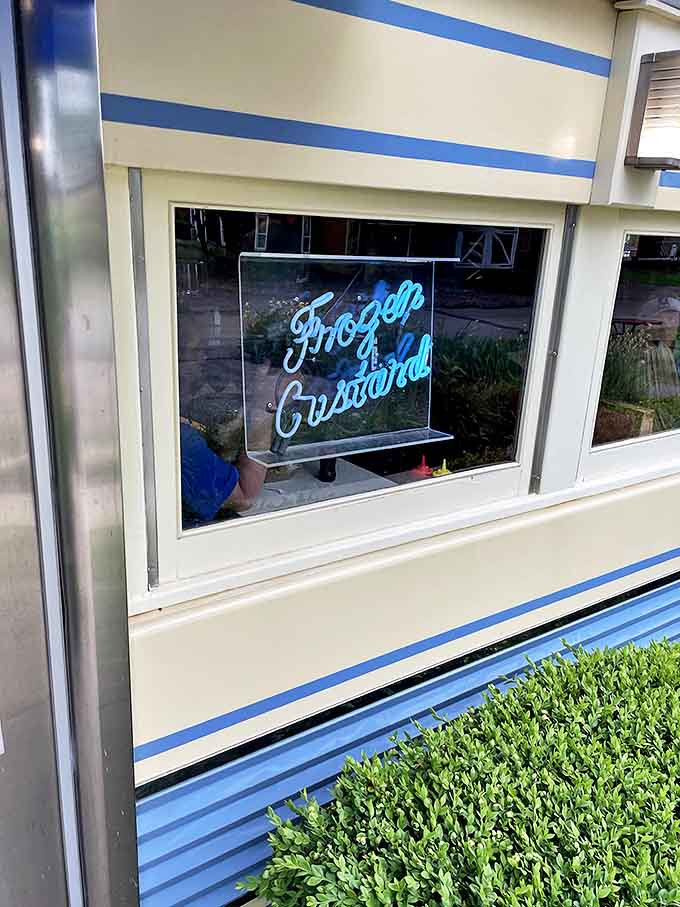The neon promise of "Frozen Custard" glows like a beacon of sweet relief. Some signs don't just advertise food – they advertise happiness.