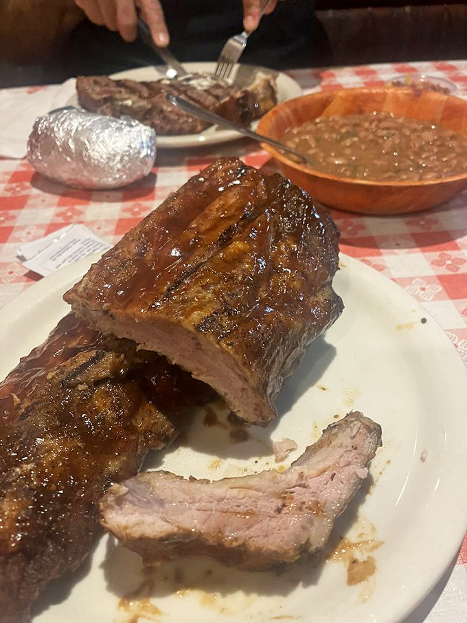 Fall-off-the-bone tender, these BBQ ribs don't just satisfy hunger &ndash; they solve life's problems one smoky, sauce-slathered bite at a time.