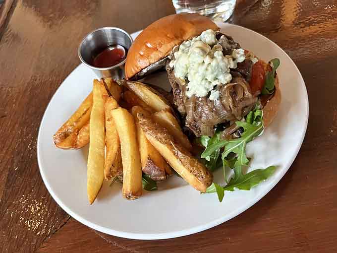 That burger is stacked so high with blue cheese and perfectly cooked beef, it's practically begging you to unhinge your jaw like a python.