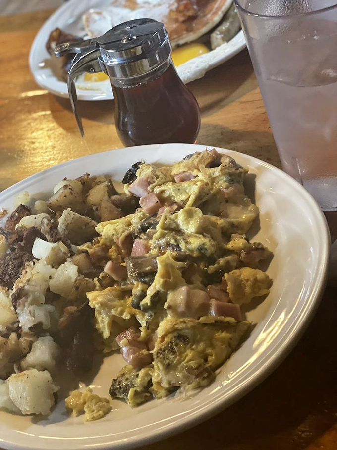 A perfect ham and cheese scramble that somehow makes eggs exciting again, paired with home fries that deserve their own fan club.