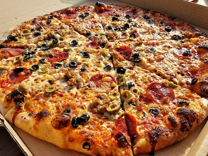 The "Hannah" pizza combines sausage, pepperoni, and olives with feta cheese for a Mediterranean twist that keeps locals coming back weekly.