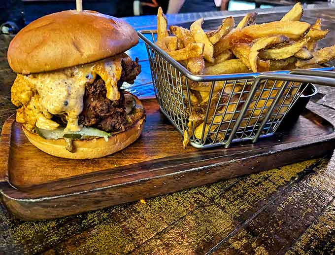 This burger means business, arriving with its own basket of fries like a champion entering the ring with an entourage.