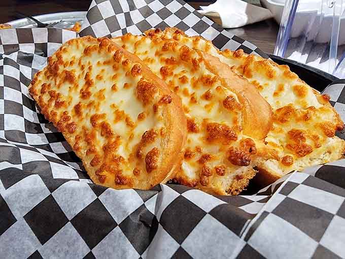 Garlic bread that's basically cheese and carbs having a delicious party on your plate.