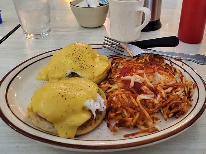 Eggs Benedict done right means perfectly poached eggs drowning in hollandaise that's rich enough to make your cardiologist nervous and delicious enough not to care.