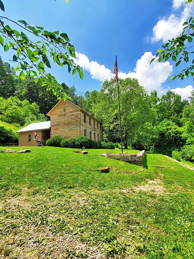The American flag stands proudly beside the stone house, both having witnessed more history than your high school textbook ever covered.