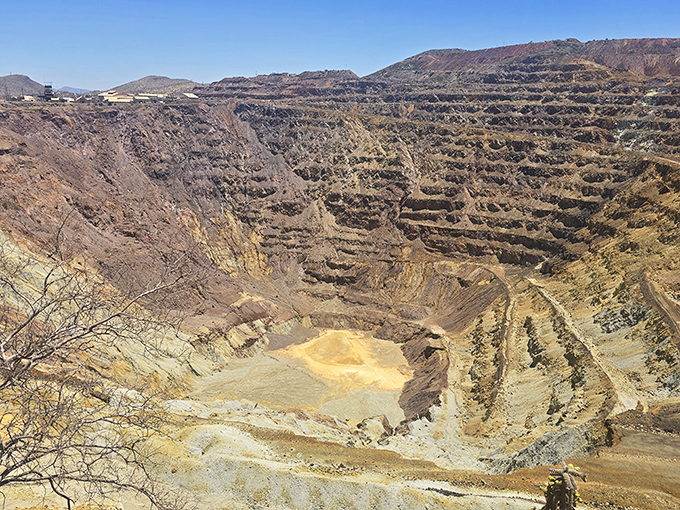The massive Lavender Pit mine resembles a giant's staircase carved into the earth, its mineral-stained terraces showcasing nature's surprising palette of oxidized metals.