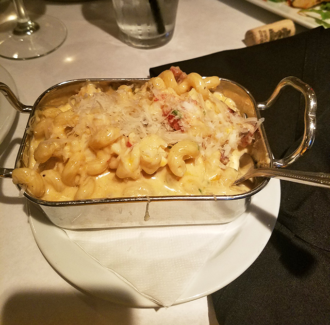 This isn't just mac and cheese – it's a silver pan of luxury where tender lobster chunks play hide and seek among creamy, cheesy pasta shells.