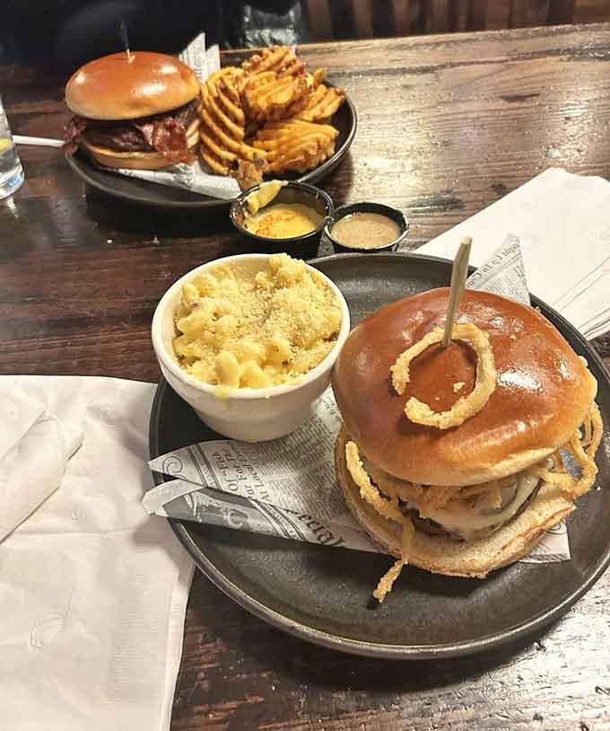 That Swiss burger comes loaded with enough toppings to require architectural planning, and those waffle fries are the perfect supporting cast.