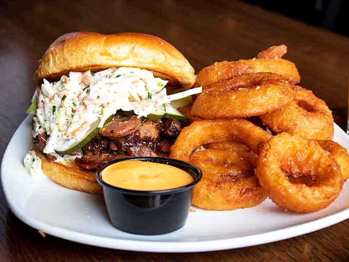That BBQ sandwich and those golden onion rings create a duo worthy of its own buddy comedy.