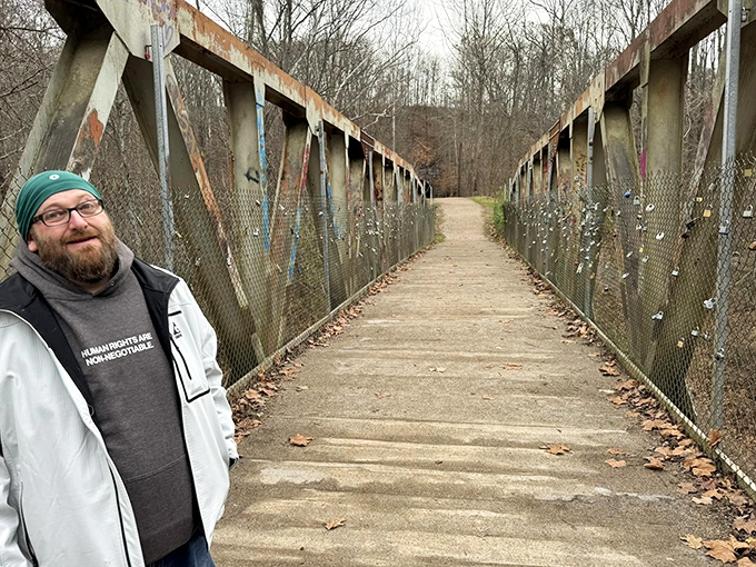 A rustic bridge spans the gentle waters, inviting trail users to pause and appreciate the engineering that has stood the test of time.