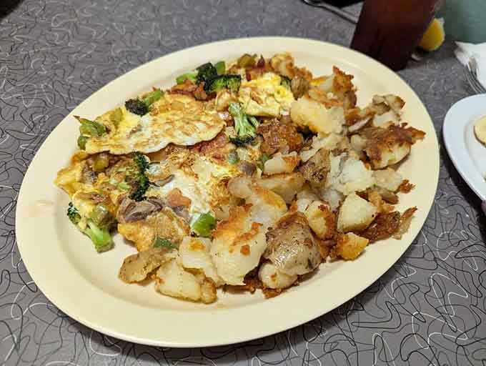 A veggie omelet loaded with fresh ingredients and crispy home fries proves that classic diner fare can satisfy every appetite.