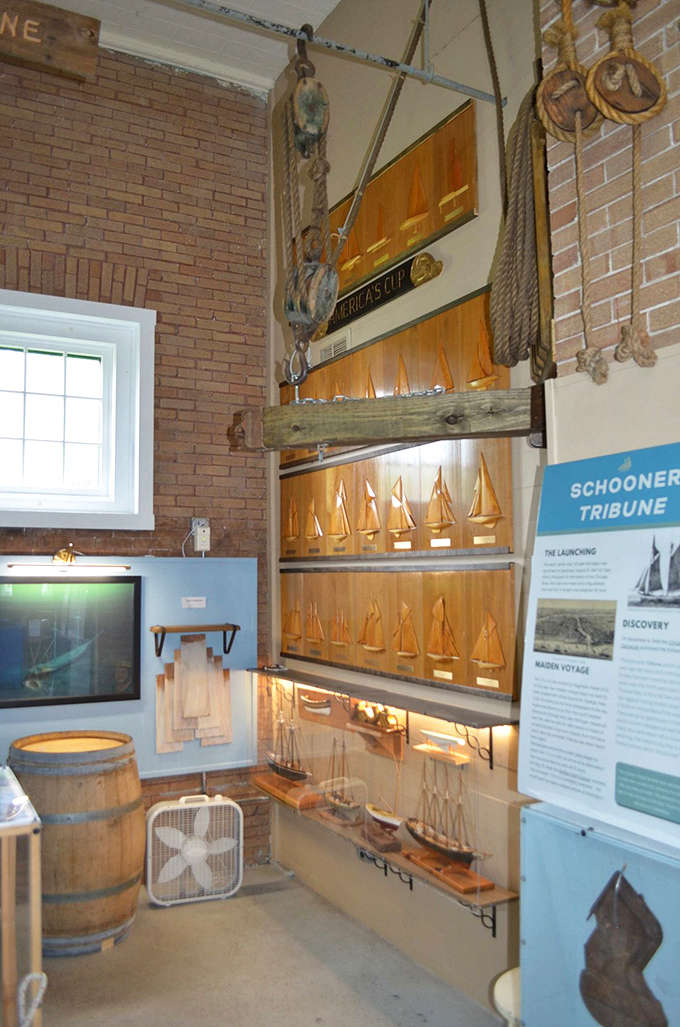 Delicate model ships showcase the various vessels that once relied on the lighthouse's guiding beam through treacherous Manitou Passage waters.