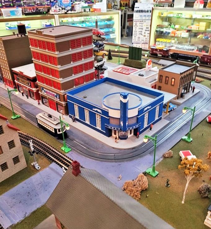 Miniature worlds come alive in this detailed layout where tiny citizens go about their business, oblivious to the giants watching their daily routines.