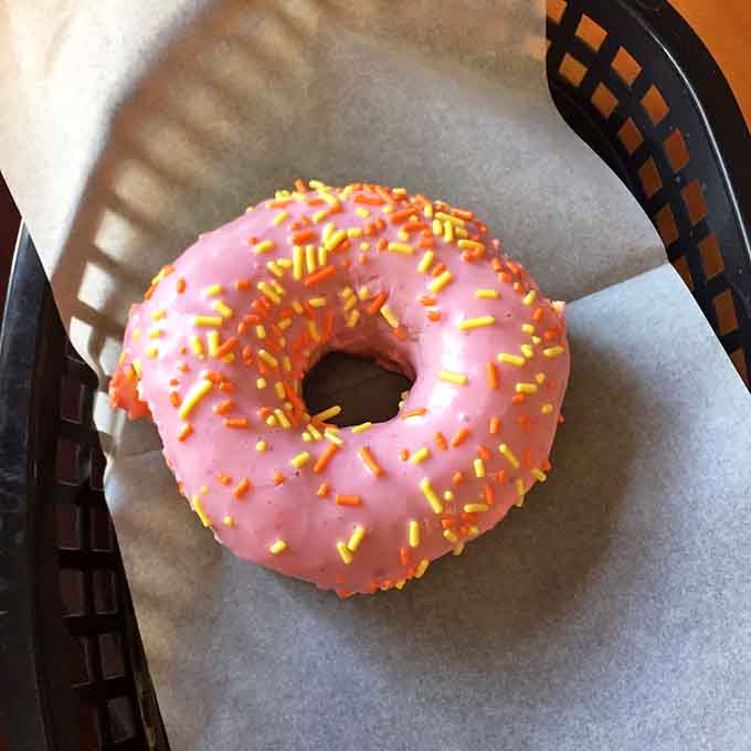 This pink beauty with sprinkles brings childhood joy to adult breakfast, because who says donuts need to be serious?