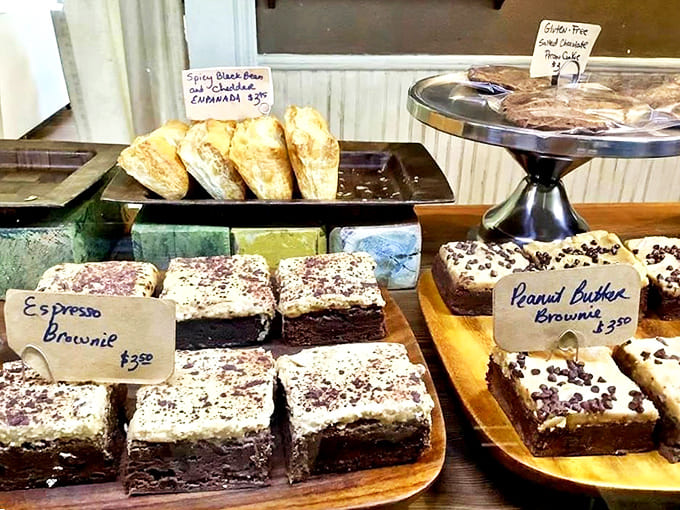 A treasure chest of baked delights awaits behind glass, each one whispering sweet promises that are impossible to resist.