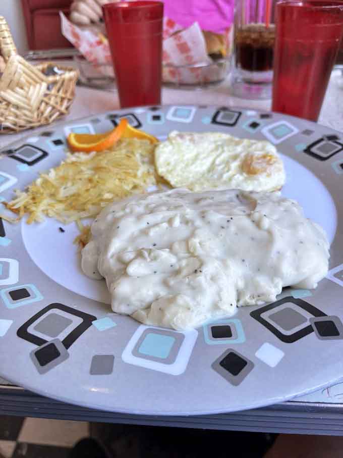 Country gravy cascading over chicken fried steak like a delicious avalanche you actually want to be caught in.