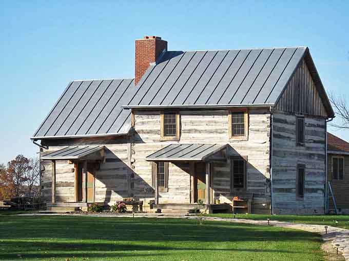 This historic log house stands as a testament to pioneer spirit, its weathered beams holding secrets of generations who called it home.