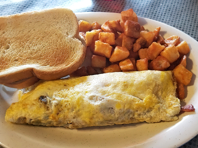 This isn't just any omelet &ndash; it's a fluffy egg masterpiece accompanied by perfectly seasoned home fries that'll make you forget fancy brunches.
