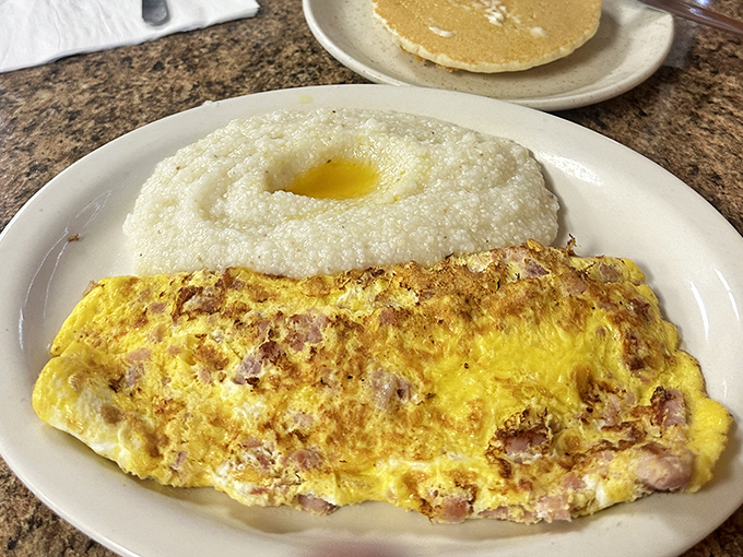 This ham-packed omelet with a side of grits is the breakfast equivalent of a warm hug &ndash; comforting, satisfying, and exactly what you need.