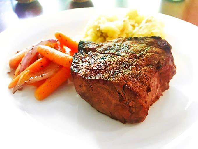 The filet mignon delivers buttery tenderness with every bite, accompanied by vibrant vegetables that actually look appetizing for once.