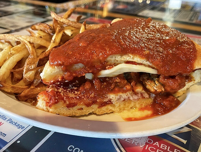 Parmesan sandwich paradise &ndash; crispy chicken, melted cheese, and marinara sauce nestled in a toasted bun with golden fries.