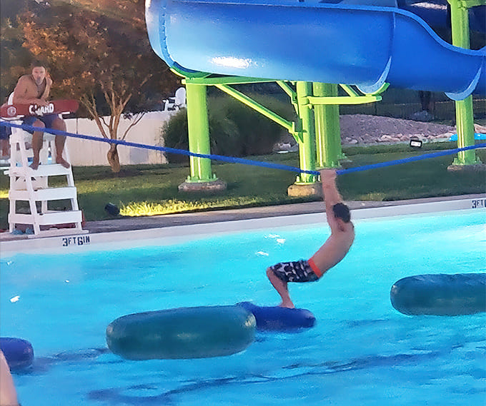 Laughter and splashes create the soundtrack of summer as families navigate pool obstacles with varying degrees of grace.