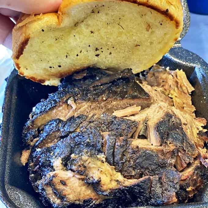 Prime brisket on a perfectly toasted bun demonstrates the beautiful simplicity of great barbecue done right without unnecessary complications.