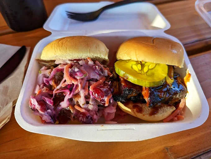 Meat poetry on a bun! Tender strands of pork shoulder alongside that vibrant slaw &ndash; a textural tango that dances across your palate.