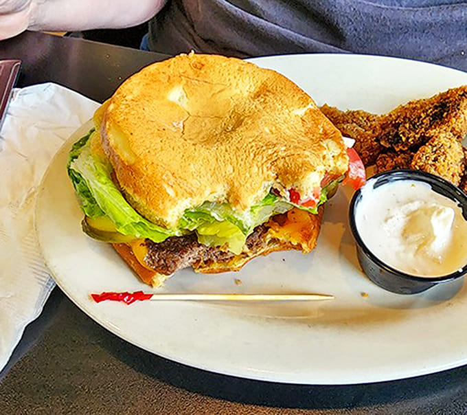 A perfectly assembled quarter-pound burger with all the fixings sits alongside golden-brown fried mushrooms &ndash; simple food executed with the care usually reserved for fancy establishments.