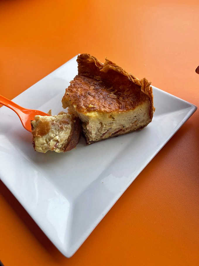 A slice of quiche that's achieved the impossible &ndash; a crust that stays crisp while cradling a filling so creamy it defies physics.