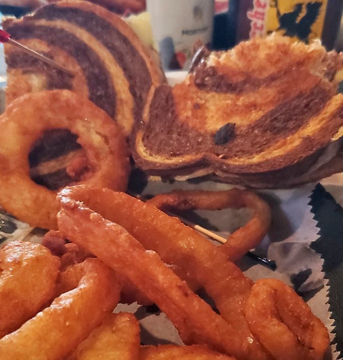 Behold the star of the show: a Reuben sandwich so perfectly constructed it deserves its own architectural award.