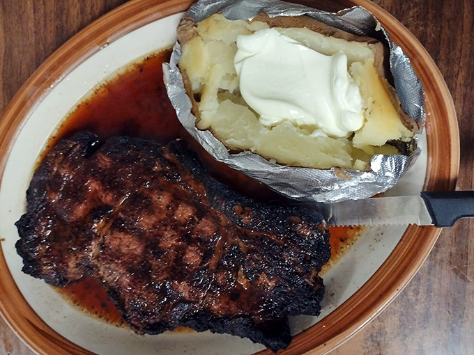 The savory au jus pools around this magnificent ribeye, creating a flavor combination that will haunt your dreams.
