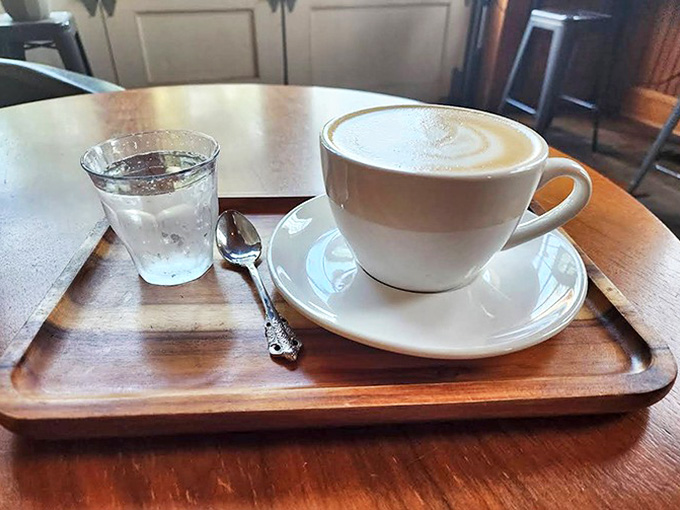 Winter comfort in ceramic form &ndash; the rich mocha sits regally on its wooden throne, accompanied by water to cleanse the palate.