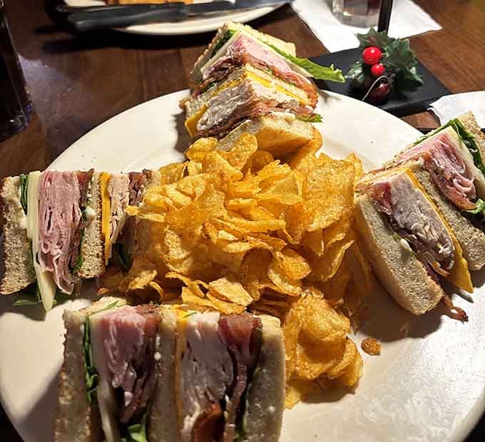 The towering club sandwich is an architectural marvel of turkey, ham, bacon, and all the fixings your heart desires.