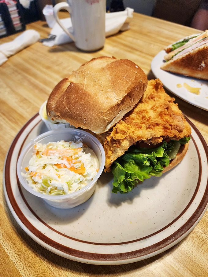 Crispy-on-the-outside, tender-on-the-inside fried chicken sandwich with house-made coleslaw &ndash; comfort food that speaks the universal language of delicious.