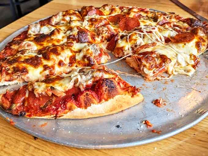 The sausage and mushroom pizza showcases DiMaggio's commitment to quality toppings that complement rather than overwhelm their perfect crust.