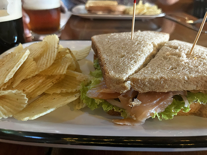 A classic smoked salmon sandwich arrives beautifully presented with fresh greens &ndash; simple ingredients allowing quality to shine through.