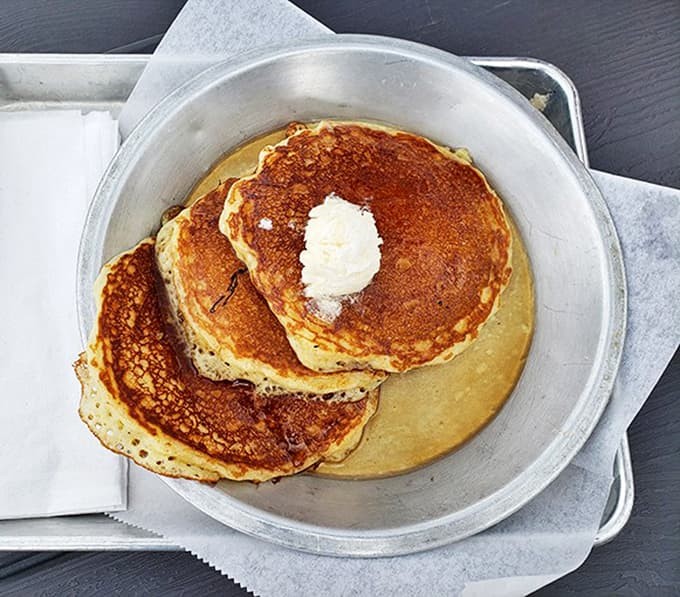 These pancakes aren't just breakfast, they're an event &ndash; golden, fluffy discs of joy topped with a melting pat of butter.