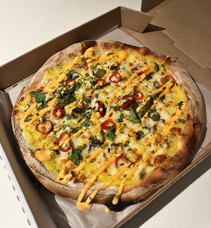 Summer on a plate: sweet corn, chili heat, and fresh herbs dance across a perfectly blistered crust in this seasonal pizza masterpiece.