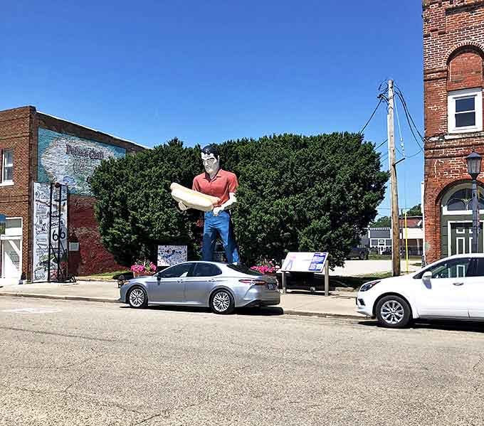 On perfect blue-sky days, the giant's vibrant red shirt and blue pants pop with a technicolor brilliance worthy of a vintage postcard.