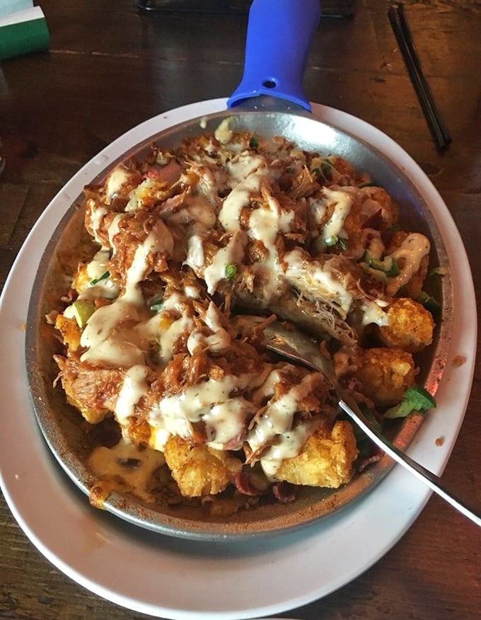 Texas Tachos redefine potato perfection – crispy tots crowned with pulled pork, jalapeños, and house-made chipotle ranch that'll make you forget regular nachos exist.