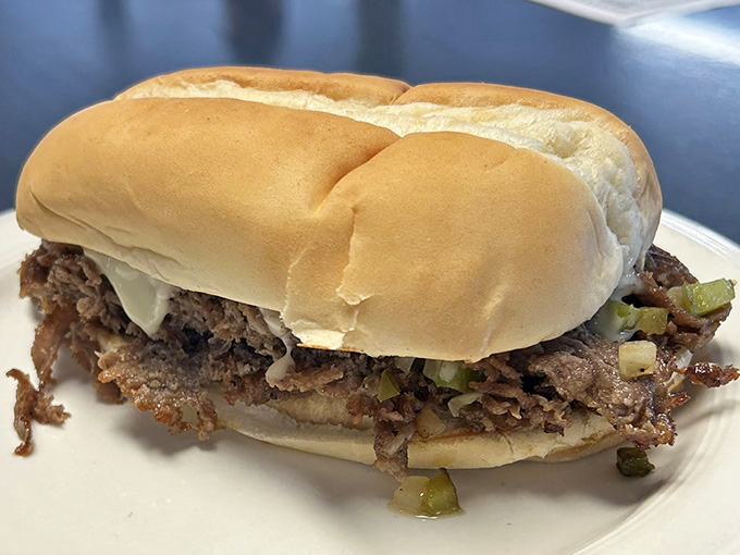 This burger wears its toppings like badges of honor, stacked high and ready to challenge your jaw's maximum capacity.