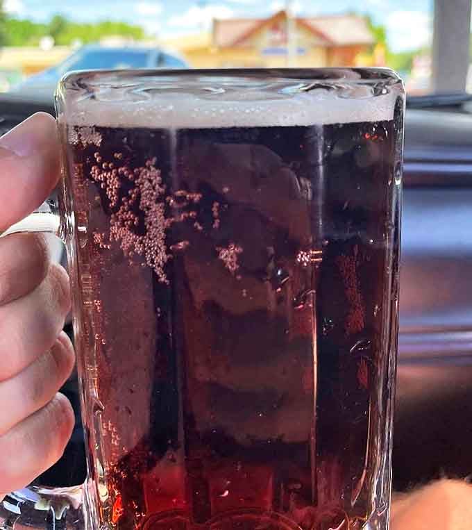 A frosty mug of house-made root beer, with that perfect foam cap and tiny bubbles dancing all the way to the bottom.