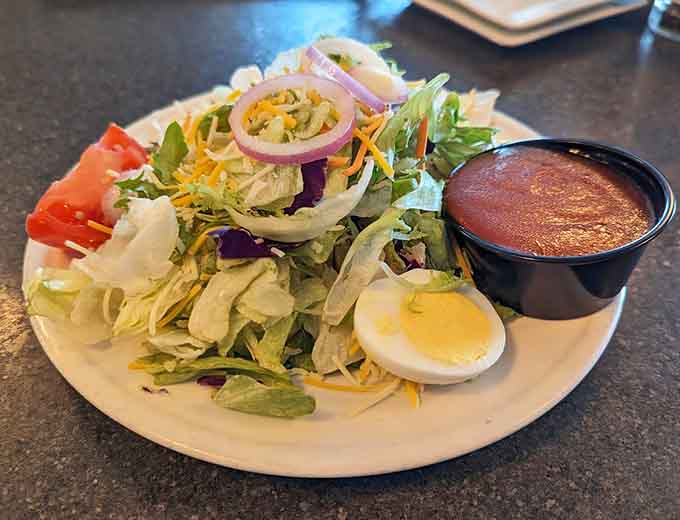 Even the house salad gets the royal treatment with fresh vegetables, hard-boiled egg, and enough toppings to feel virtuous.