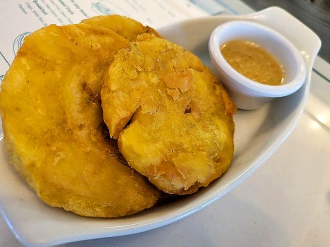 Twice-fried plantain discs that achieve the impossible &ndash; crispy exteriors giving way to tender centers, perfect for dipping in that garlicky mojo sauce.
