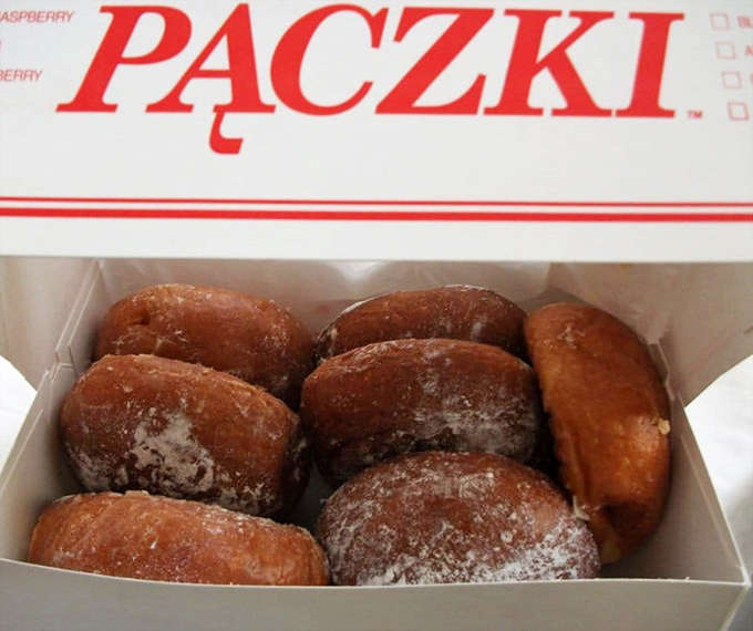A box of traditional pączki—Polish-style donuts dusted with powdered sugar—represents Detroit's cultural heritage in delicious, portable form.