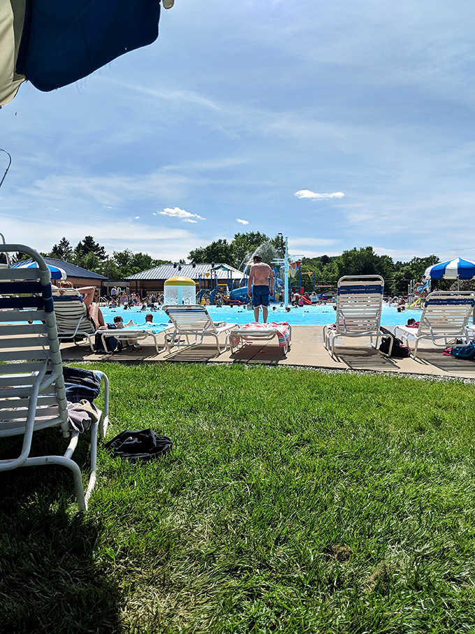 Lounge chairs await their sunbathing occupants while the pool beckons in the background &ndash; the eternal summer dilemma in one frame.