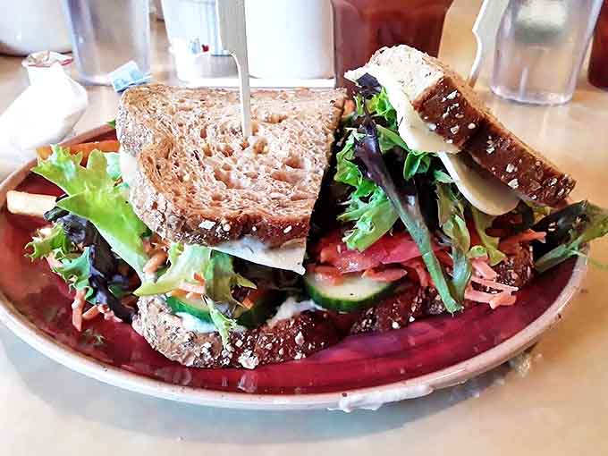 This towering vegetarian sandwich proves that skipping meat doesn't mean skipping flavor, with layers of fresh vegetables creating a rainbow of deliciousness.