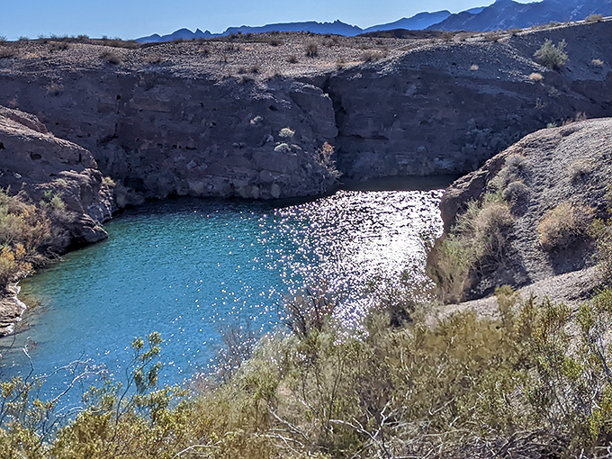 This hidden viewpoint rewards hikers with panoramic vistas of the lake's azure waters contrasting brilliantly against the harsh desert landscape.