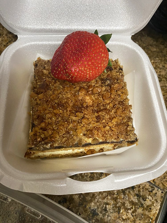 This walnut delight isn't just dessert; it's the grand finale to your Polish feast, crowned with a fresh strawberry like a ruby on velvet.